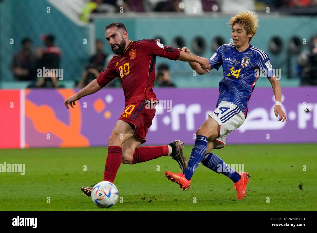 Spain's Dani Carvajal, left, and Japan's Junya Ito battle for the ball ...