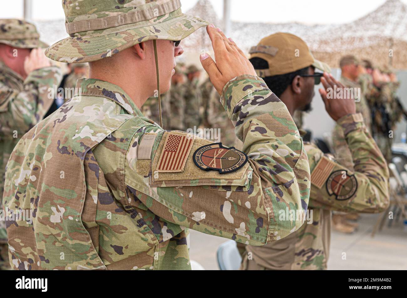 U.S. Airmen with the 378th Expeditionary Security Forces Squadron, render a salute during the ...