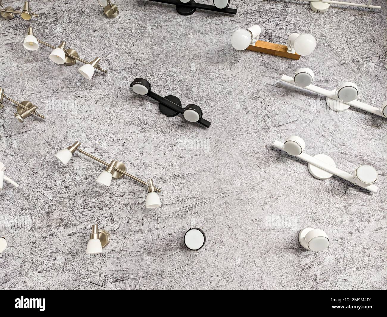 Lots of white and black lamps on the wall. Electrical goods ...