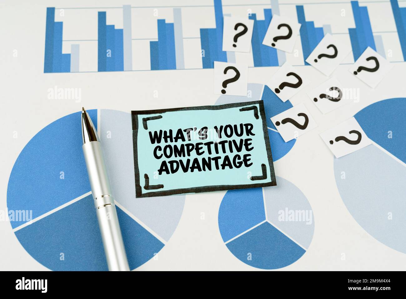 business question concept. On the blue diagrams lies a pen, questions ...