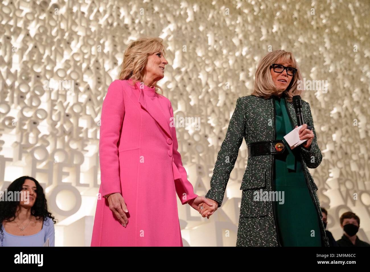 French President Emmanuel Macron's wife, Brigitte Macron, holds hands ...