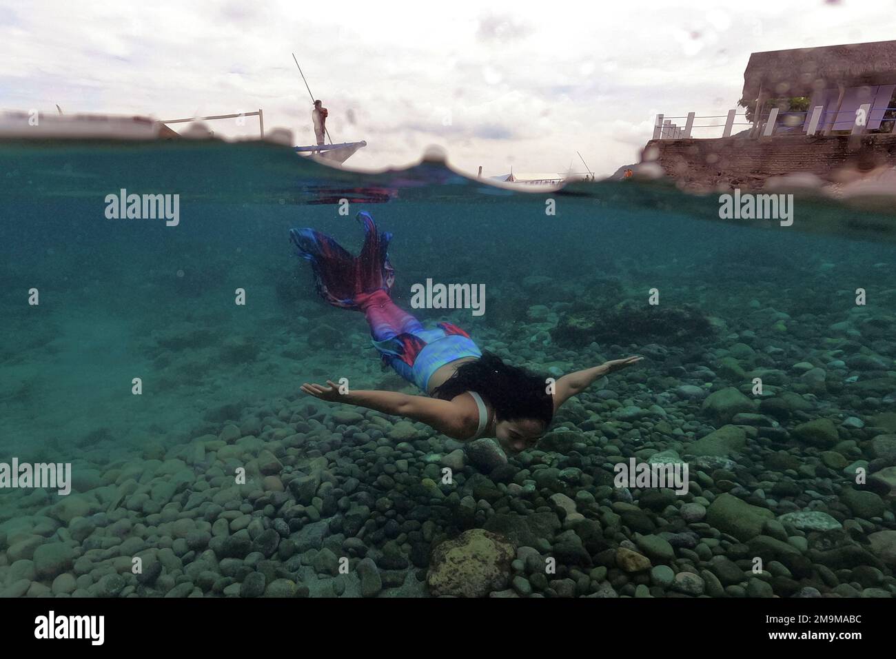 Jennica Secuya swims in her mermaid suit during a mermaiding class in ...