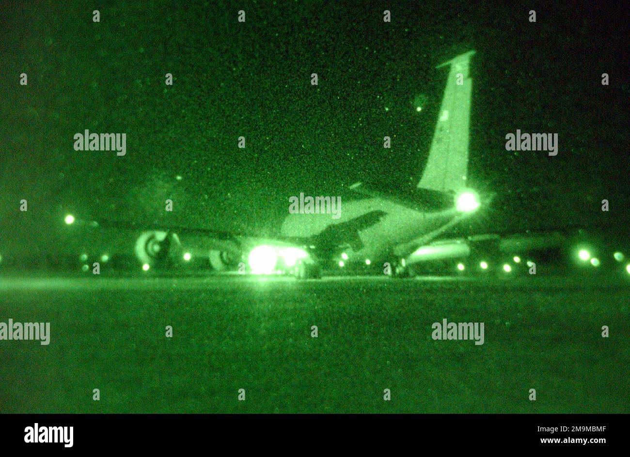 At night, a US Air Force (USAF) KC-135R Stratotanker is towed from its ...