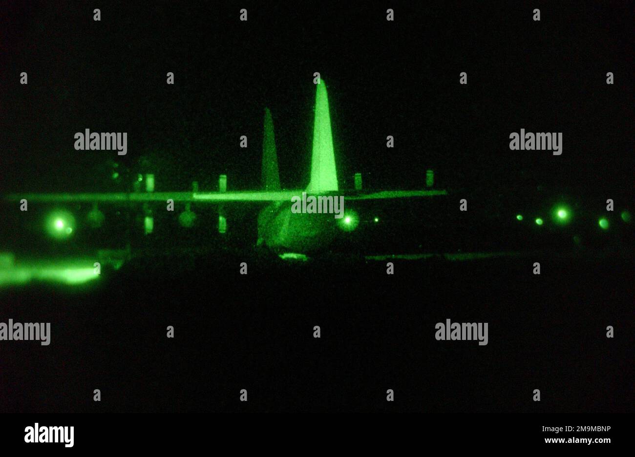 A nightscope view of US Marine Corps (USMC) KC-130 Hercules being ...