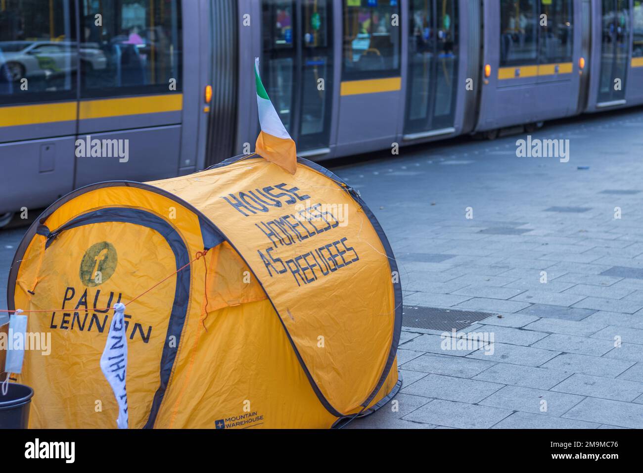 A small yellow sleeping tent in the street during a protest against ...