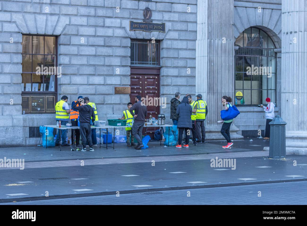 Homeless people waiting for food in front of the general post office ...