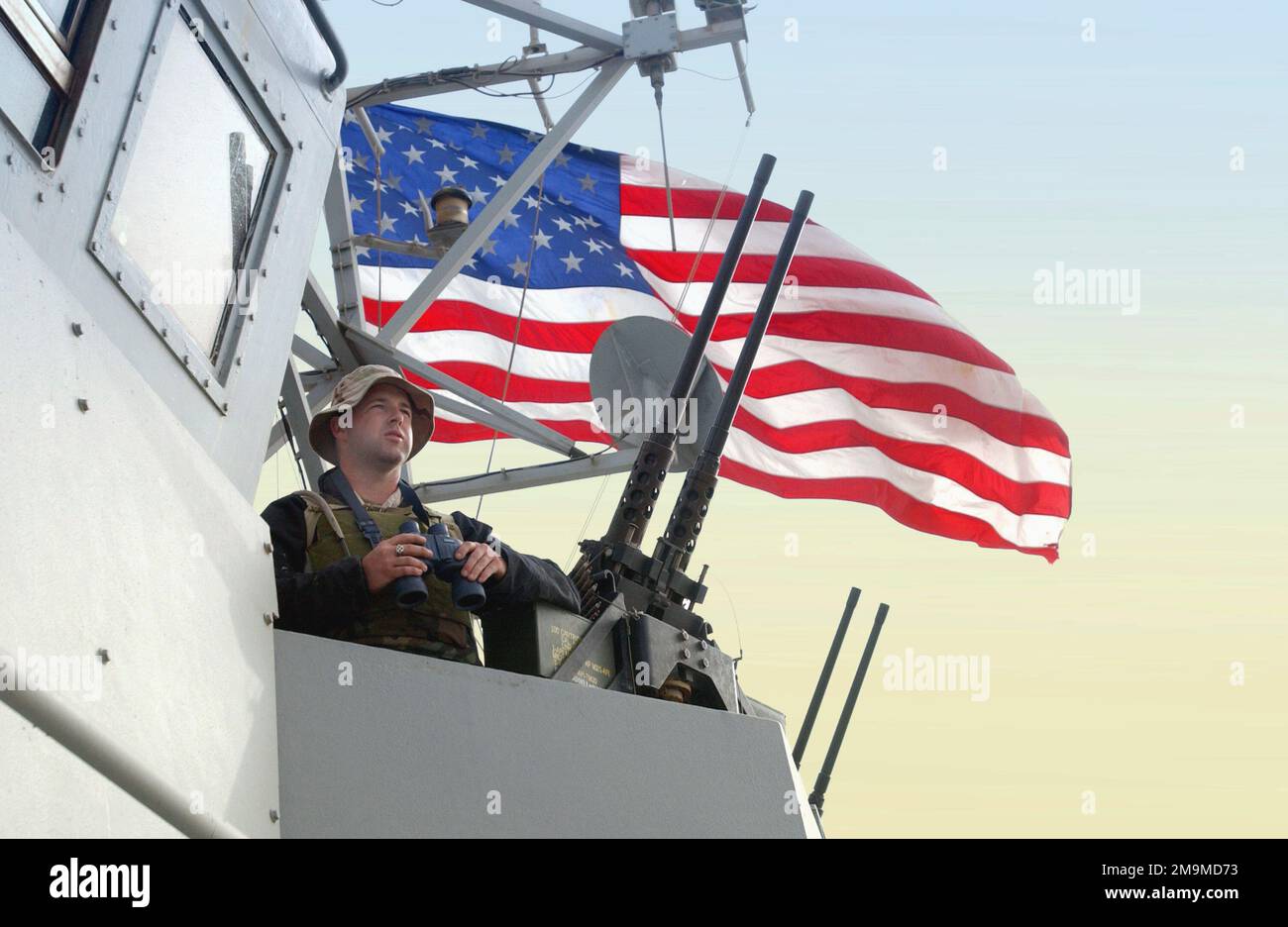 US Navy (USN) Boatswain's Mate Second Class (BM2) Ron Spencer, scans ...