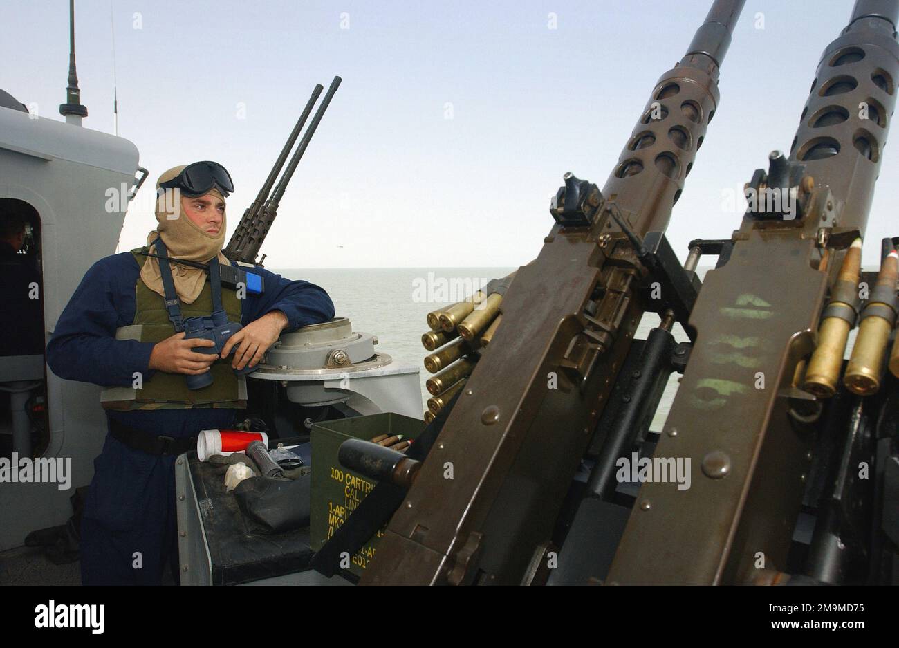 US Navy (USN) Engineman Third Class (EN3) Edward Bessette, stands next ...