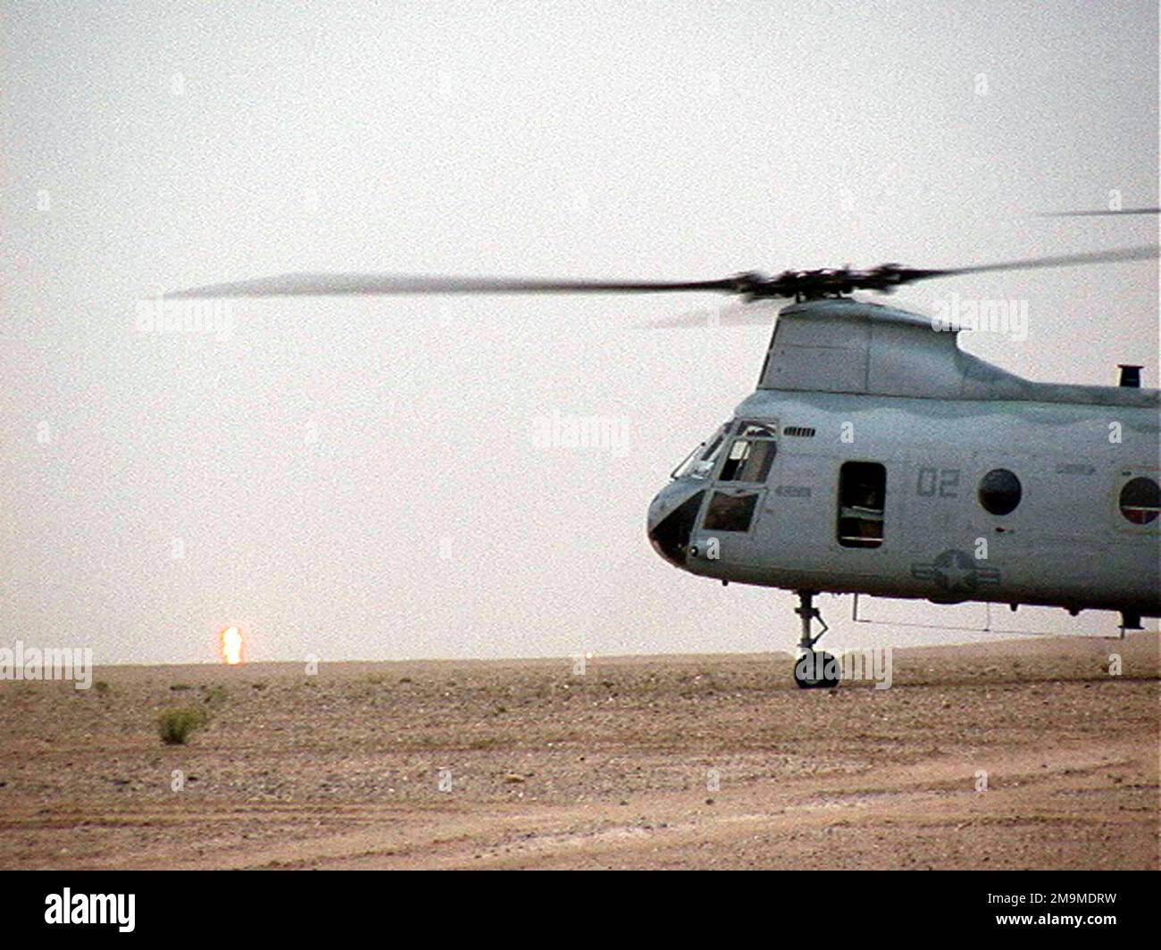 A US Marine Corps (USMC) CH-46 Sea Knight turns rotors in preparation ...