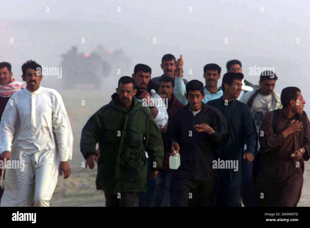 Southern Iraqi men watch US Marine Corps (USMC) activities south of ...