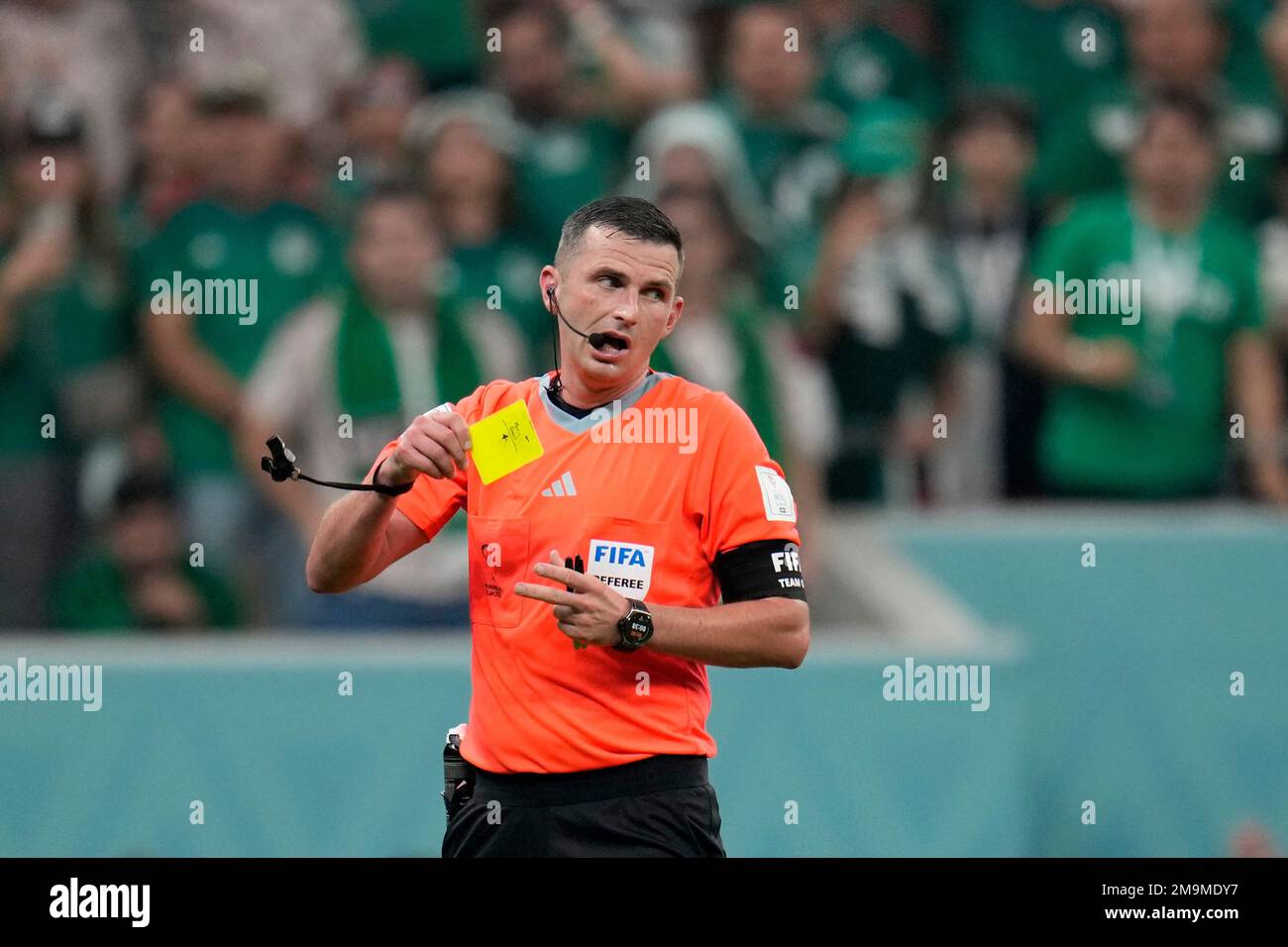 Referee Michael Oliver shows a yellow card to Saudi Arabia's Abdullah ...