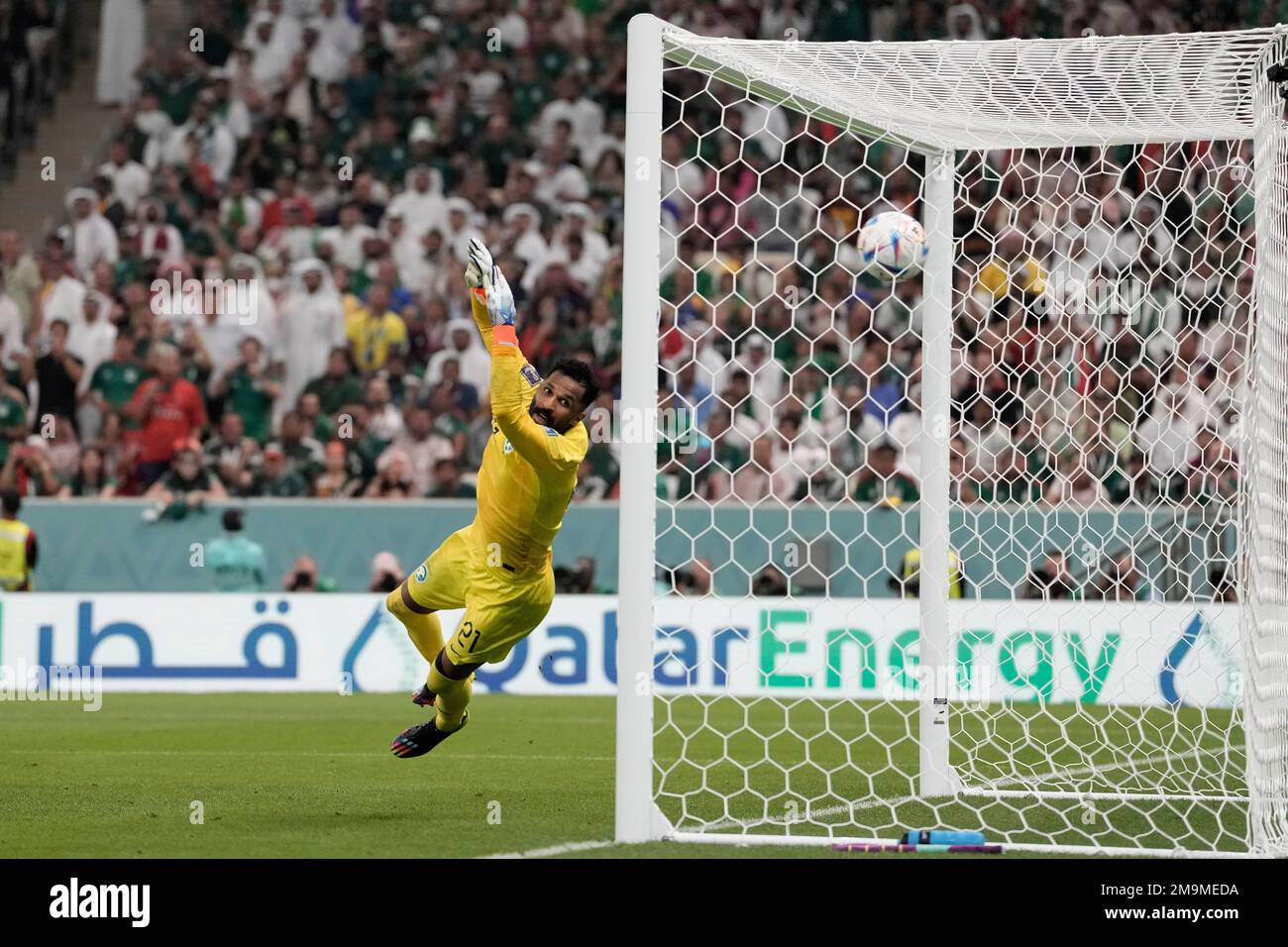 Saudi Arabia's goalkeeper Mohammed Al-Owais cannot save a free kick ...