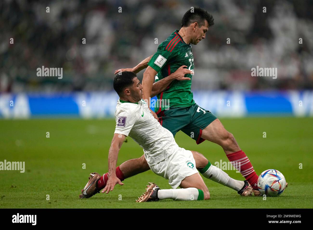 Saudi Arabia's Sultan Al-Ghanam, left, and Mexico's Hirving Lozano vie ...