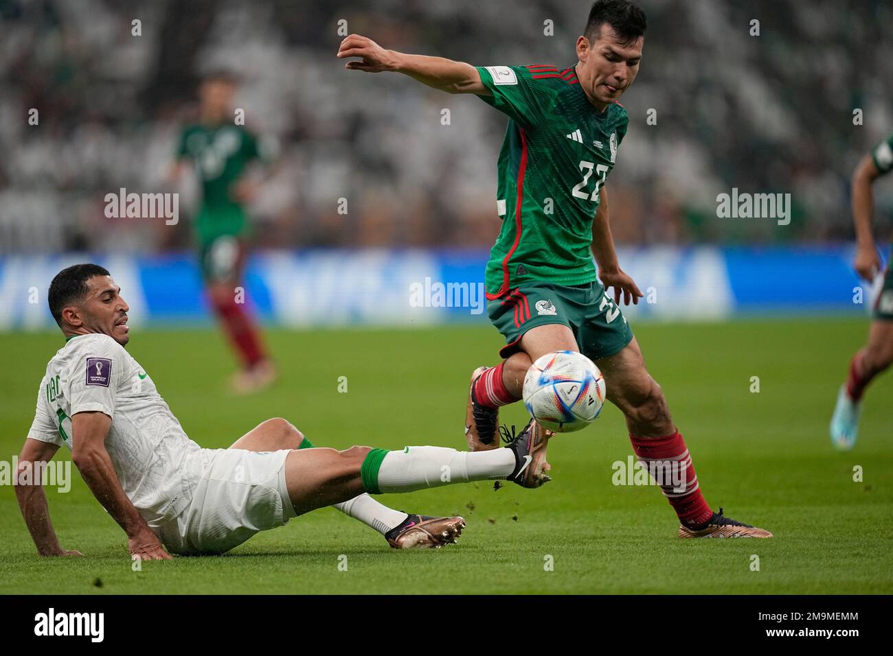 Saudi Arabia's Sultan Al-Ghanam, left, and Mexico's Hirving Lozano vie ...