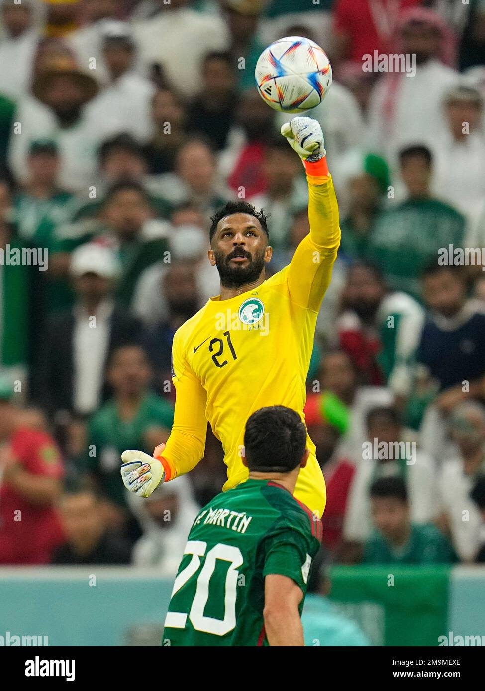 Saudi Arabia's goalkeeper Mohammed Al-Owais stops a shot above Mexico's ...