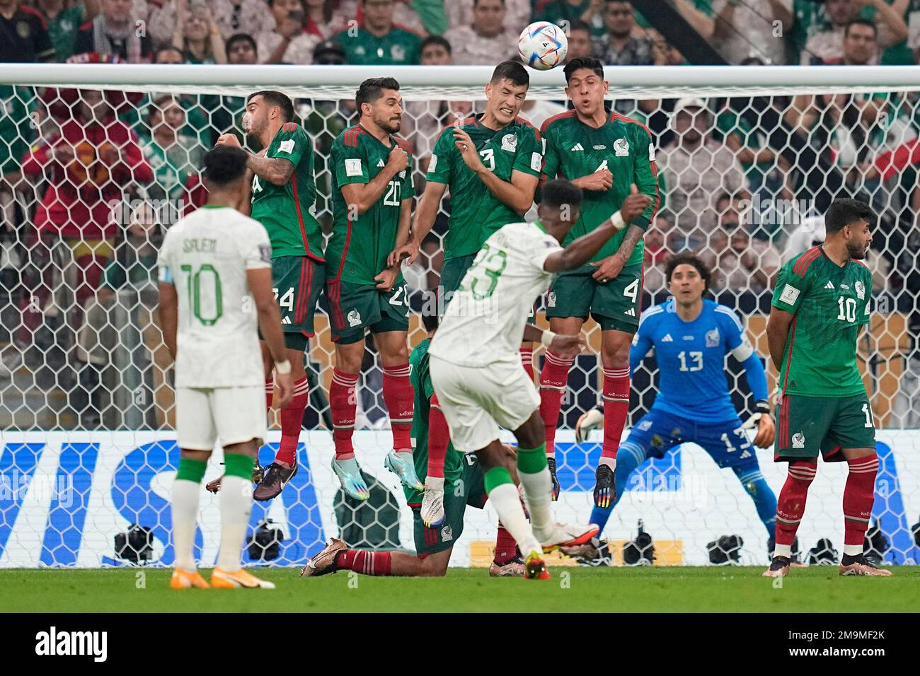 Mexico's players jump to defend against a free kick during the World ...