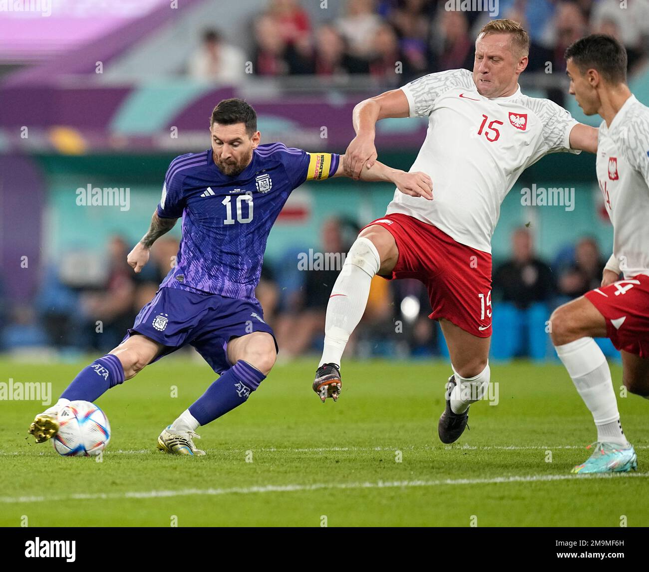Argentina's Lionel Messi, left, duels for the ball with Poland's Kamil ...