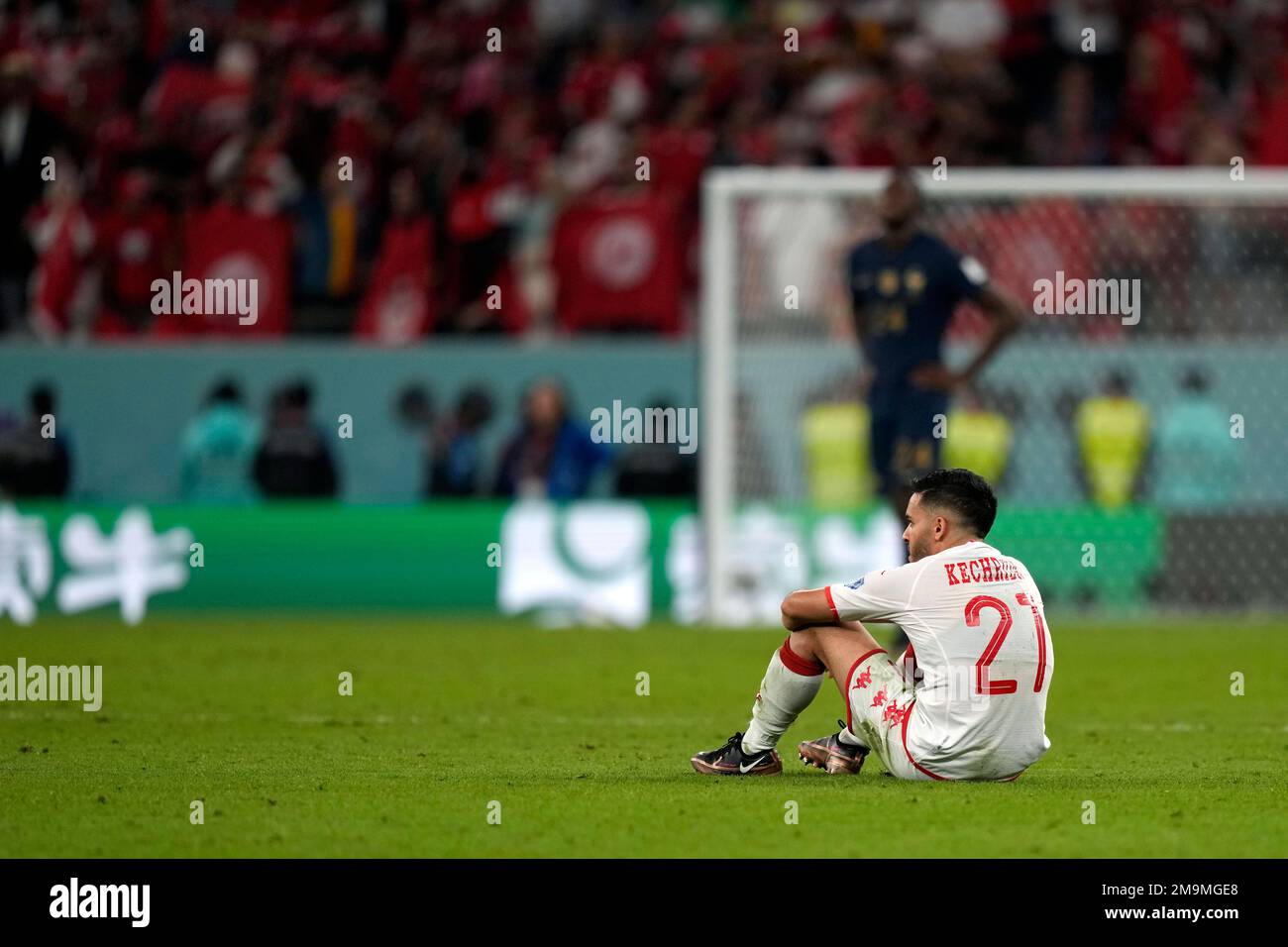 Tunisia's Wajdi Kechrida sits after his side's 1-0 victory over France ...