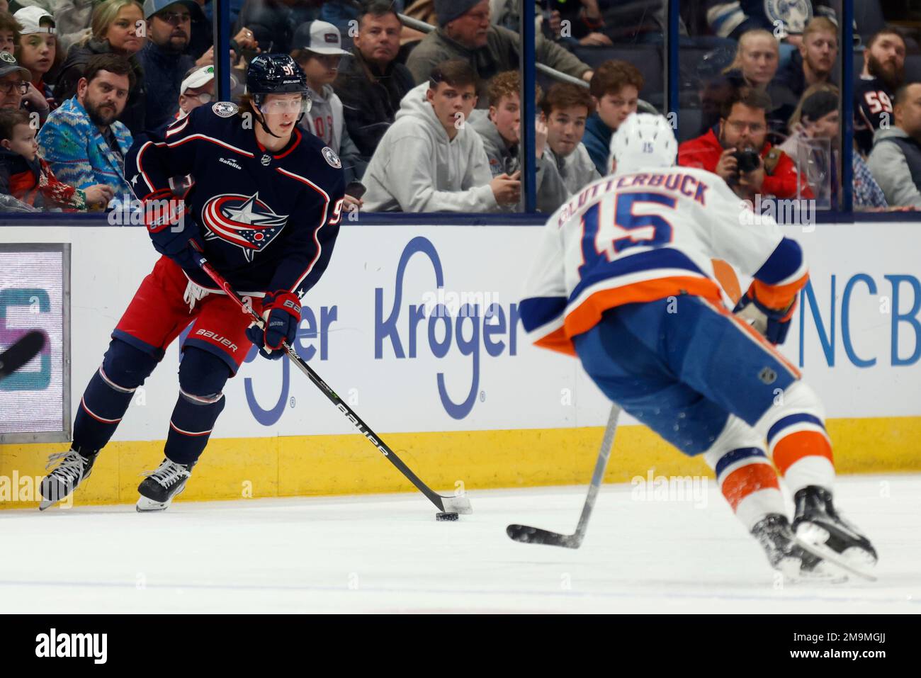 Columbus Blue Jackets forward Kent Johnson, left, controls the puck in ...