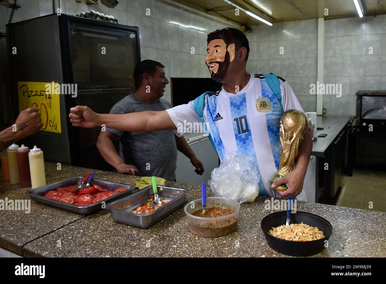 The cook wearing a Messi mask, an Argentine-motif soccer jersey and ...