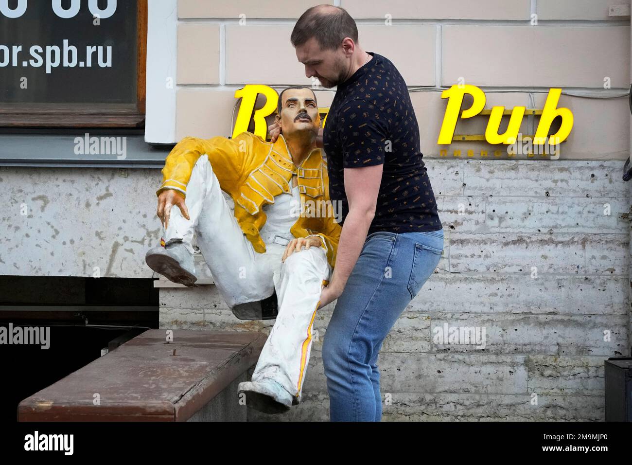 A pub employee installs a figure of rock band Queen lead singer Freddie ...