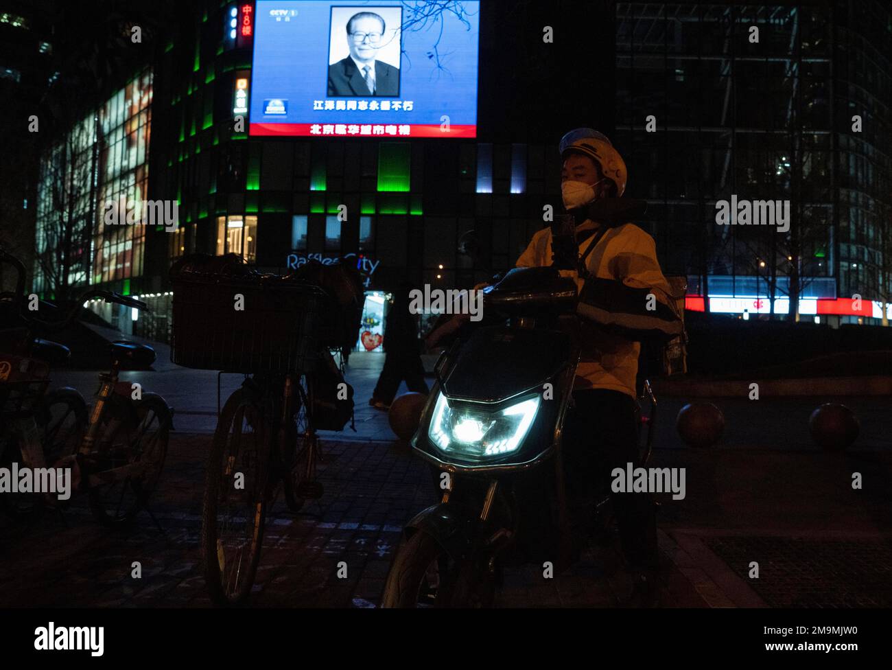 A photo of late Chinese President Jiang Zemin is seen on a big screen ...