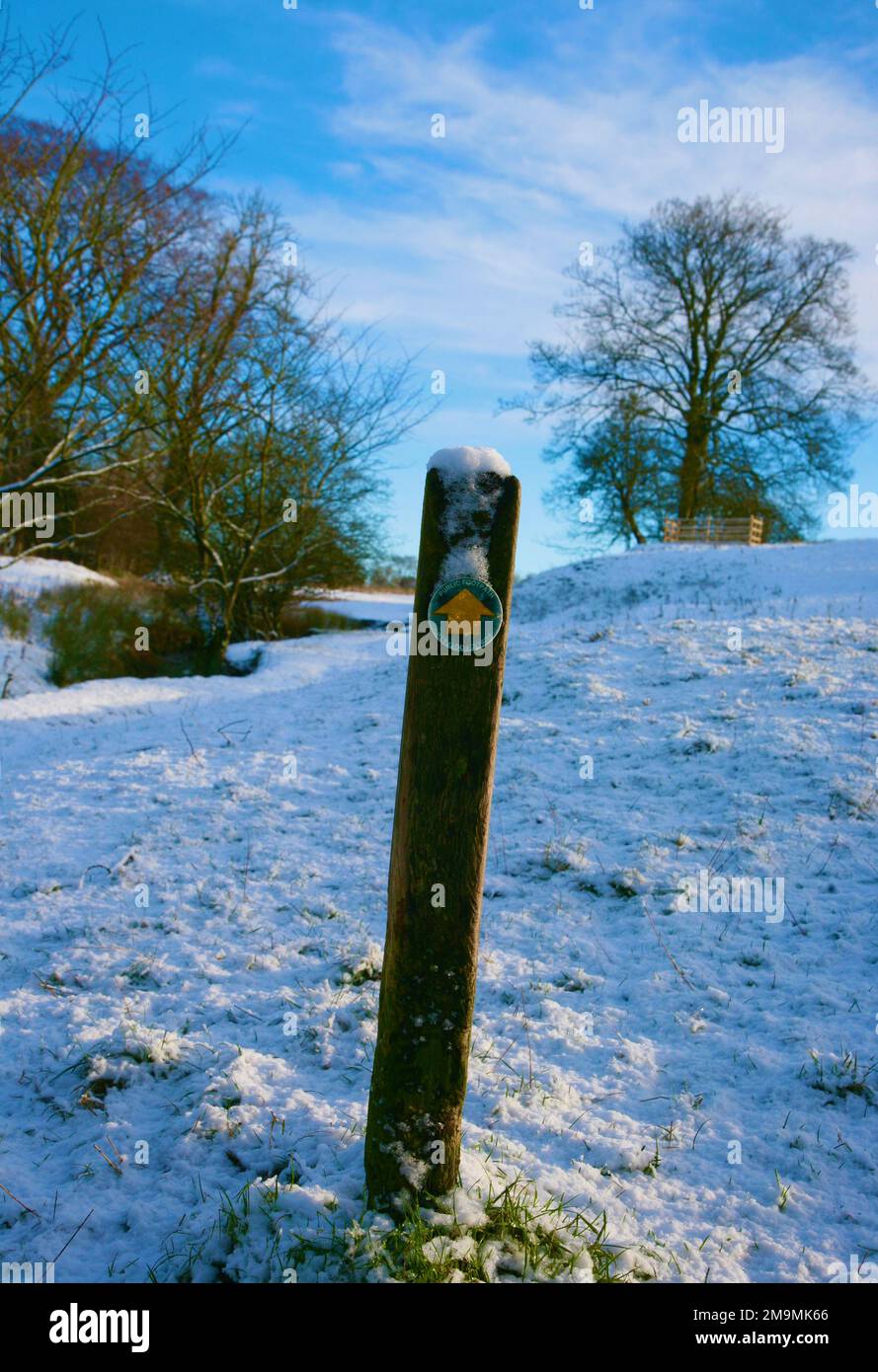 A sign for the public footpath at the edge of the village, Downham ...