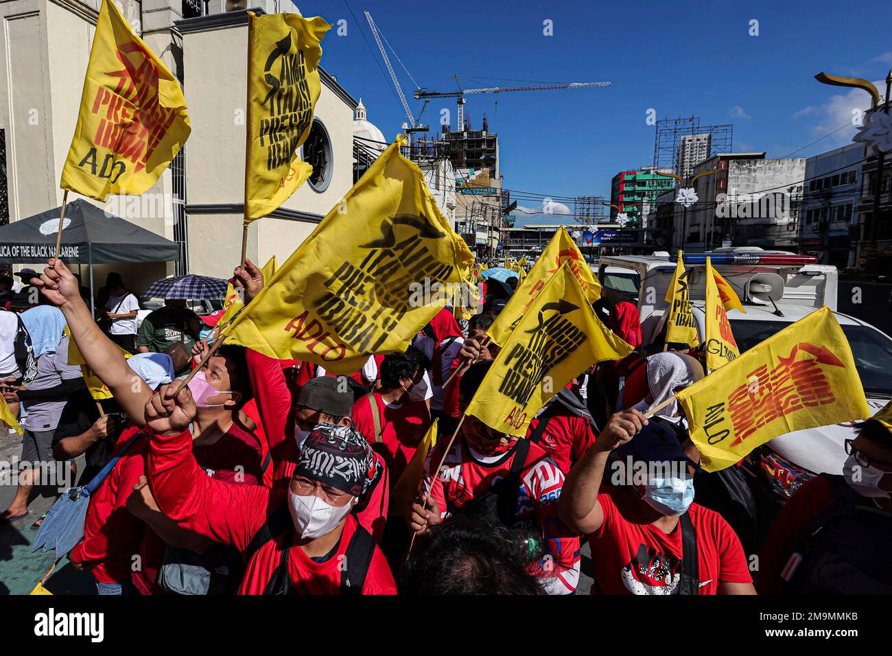 Protesters raise small flags and chant slogans during a labor march on ...