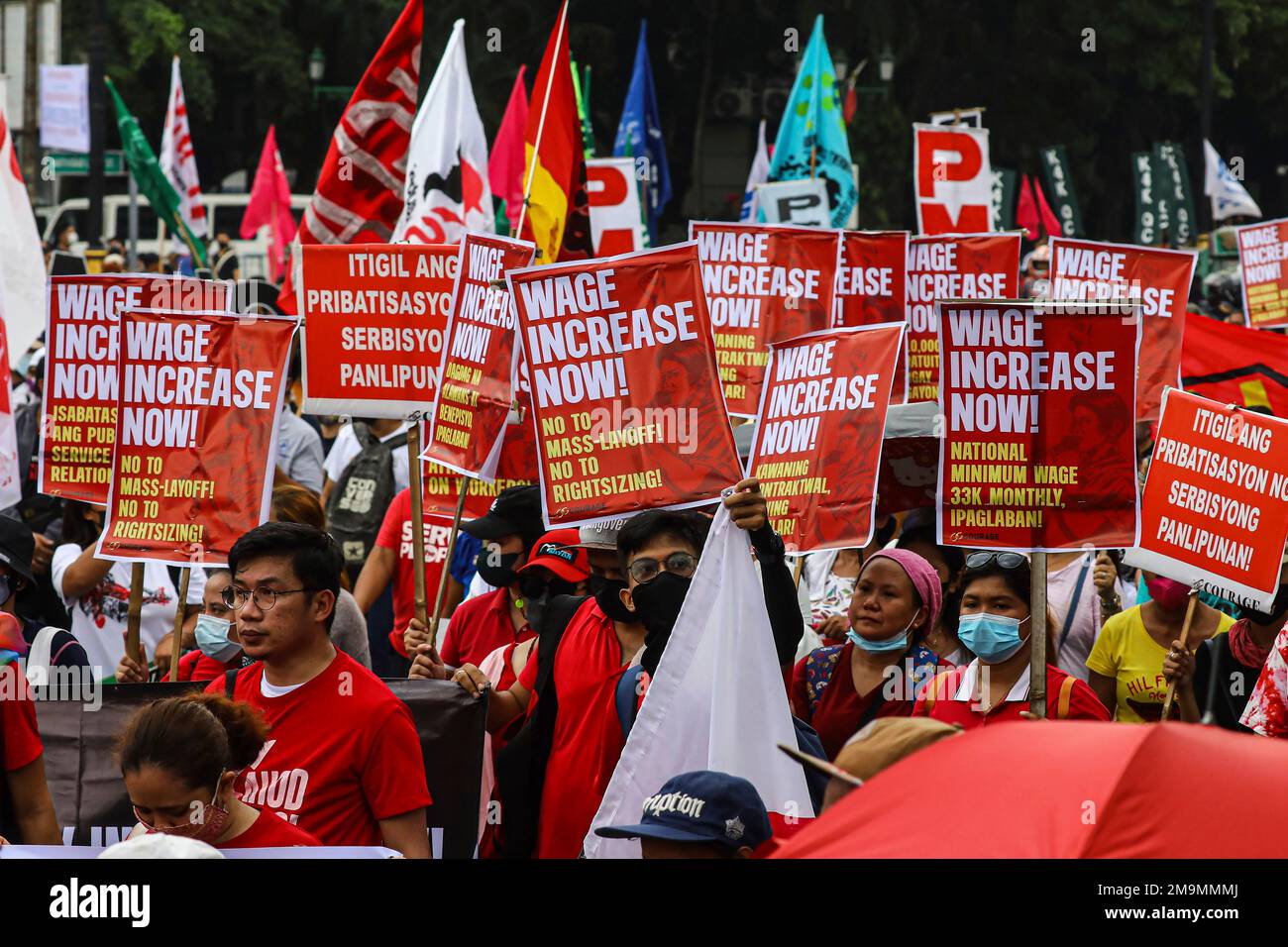 Workers carry placards during a labor march on Bonifacio Day, Wednesday ...