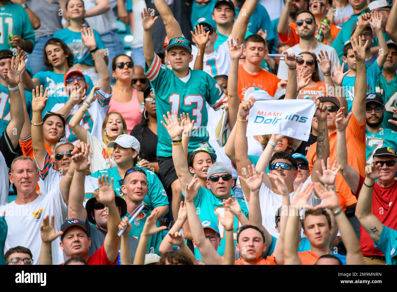 Miami Dolphins fans cheer and hold signs in the stands during an NFL ...