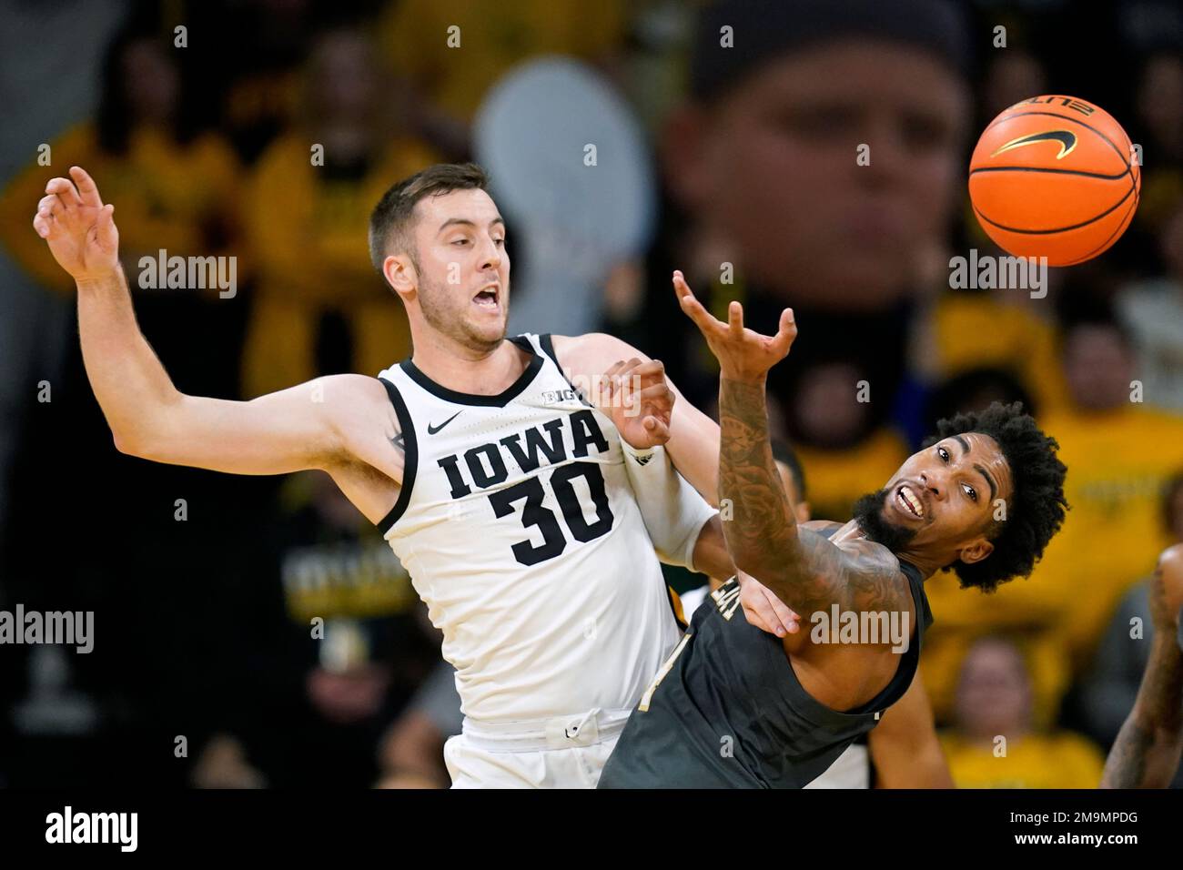 Iowa guard Connor McCaffery (30) fights for a loose ball with Georgia ...