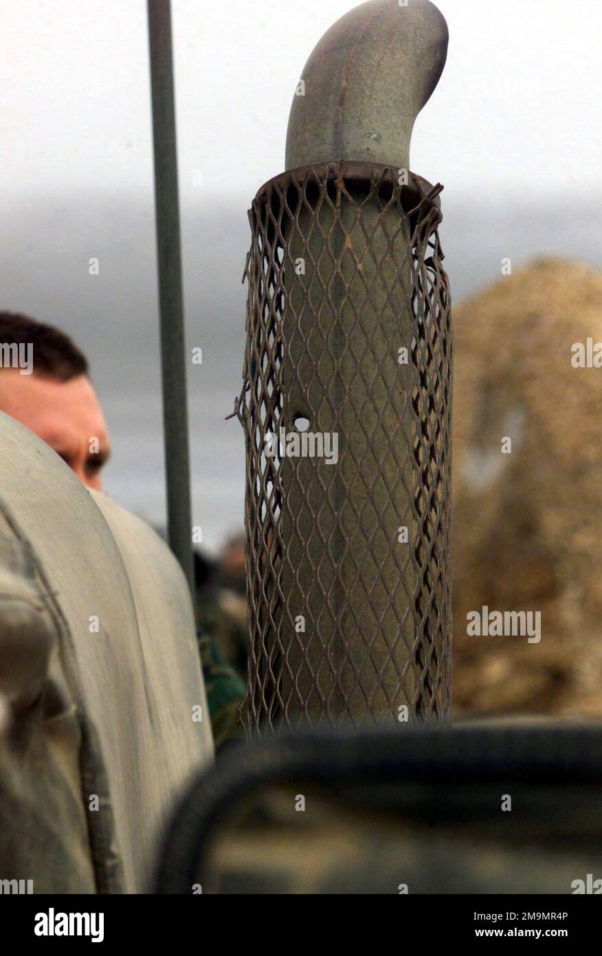 Small arms damage to an exhaust pipe on a United States military ...