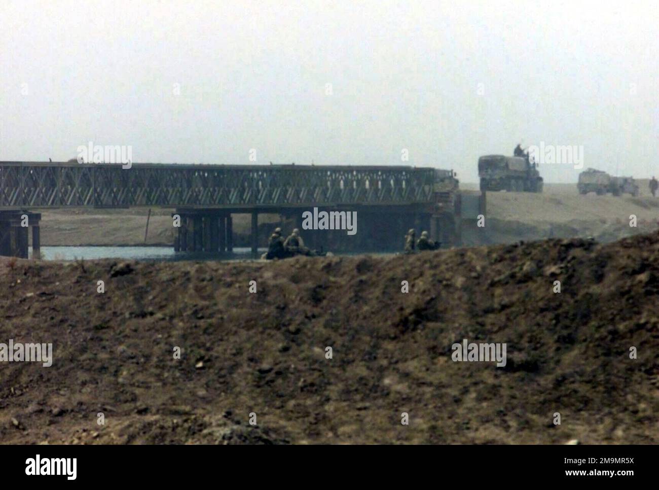 United States Marine Corps (USMC) military vehicles convoy across a ...