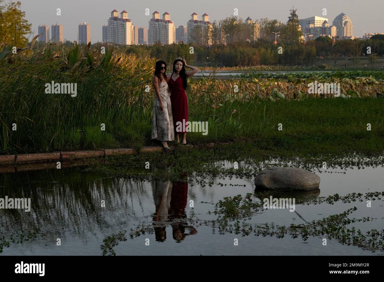 Chinese woman pose for photos near ponds and water plants at the "Fish ...