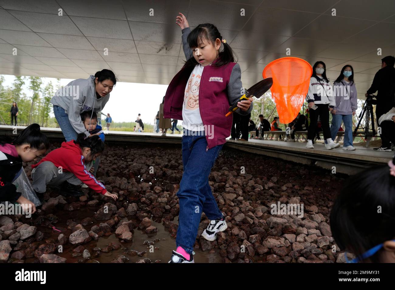 Residents walk through an area covered in permeable volcanic rocks at ...