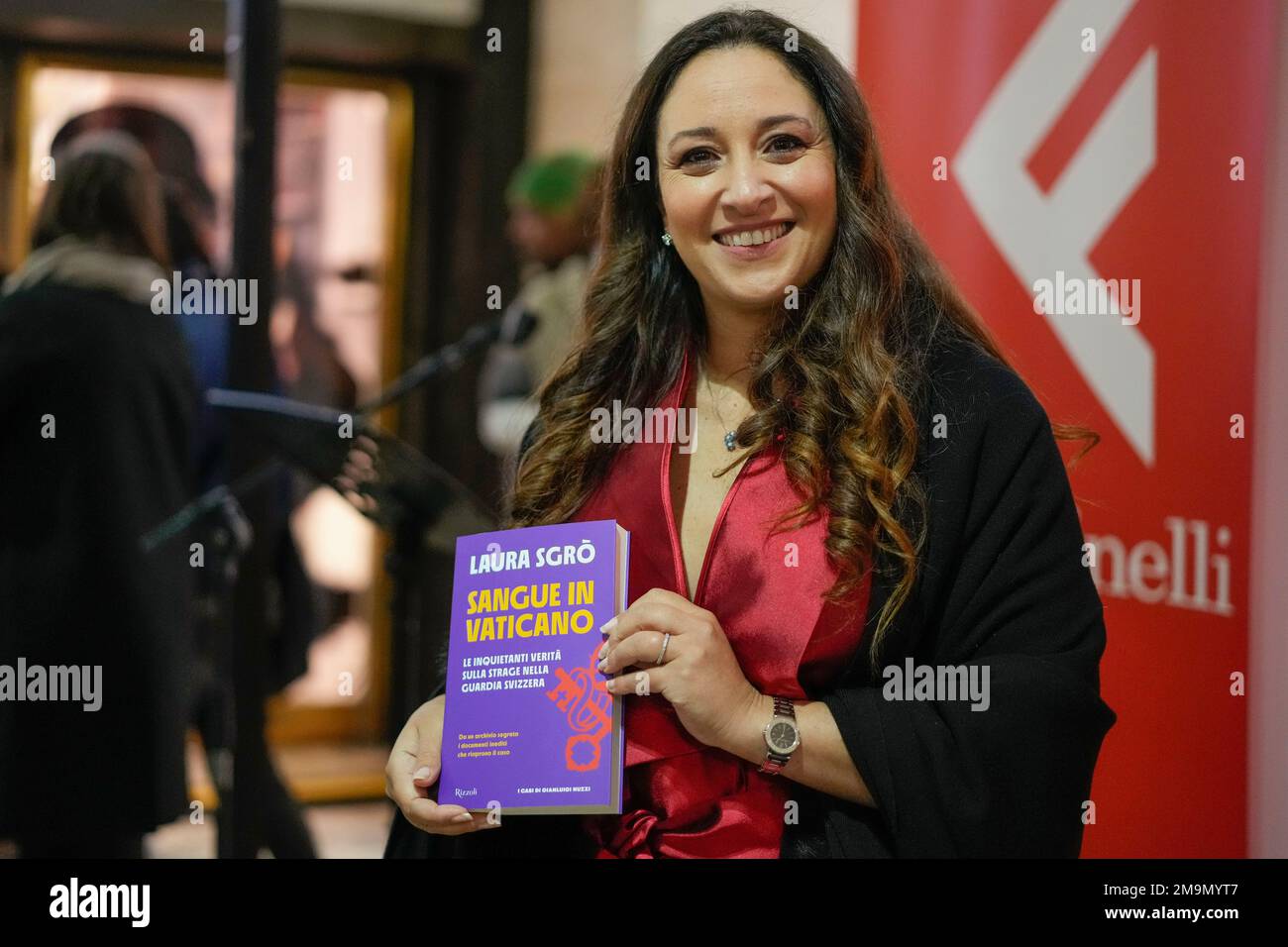 Lawyer Laura Sgro' poses with a copy of her book Sangue in Vaticano ...
