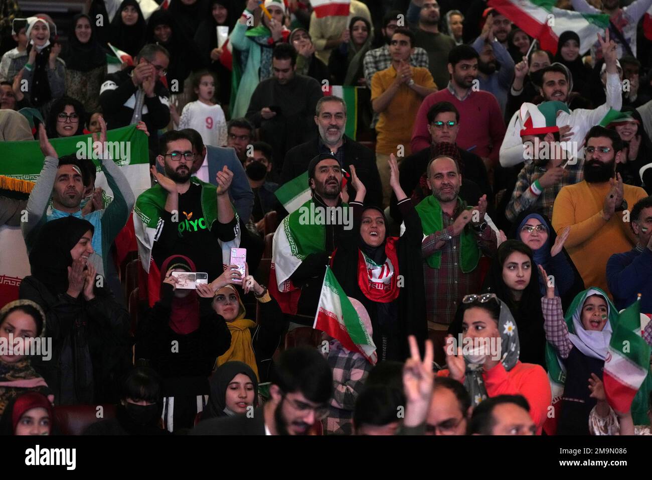 Iranian fans watch their national soccer team play against the United ...