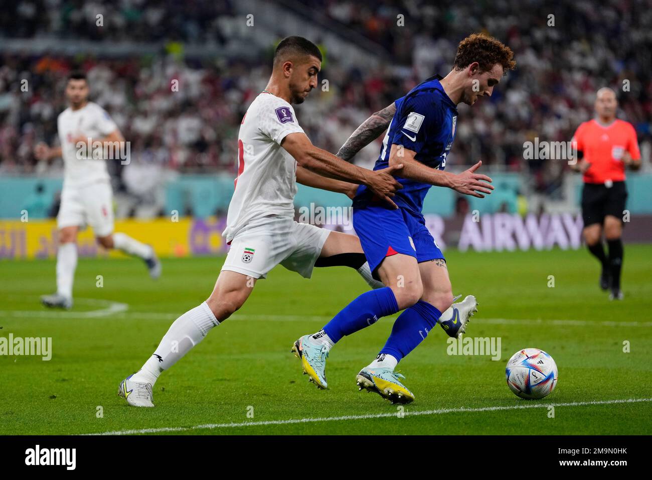 Iran's Ali Karimi, left, challenges Josh Sargent of the United States ...