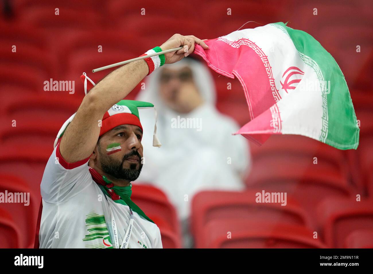An Iranian soccer fans waves a flag before the World Cup group B soccer ...