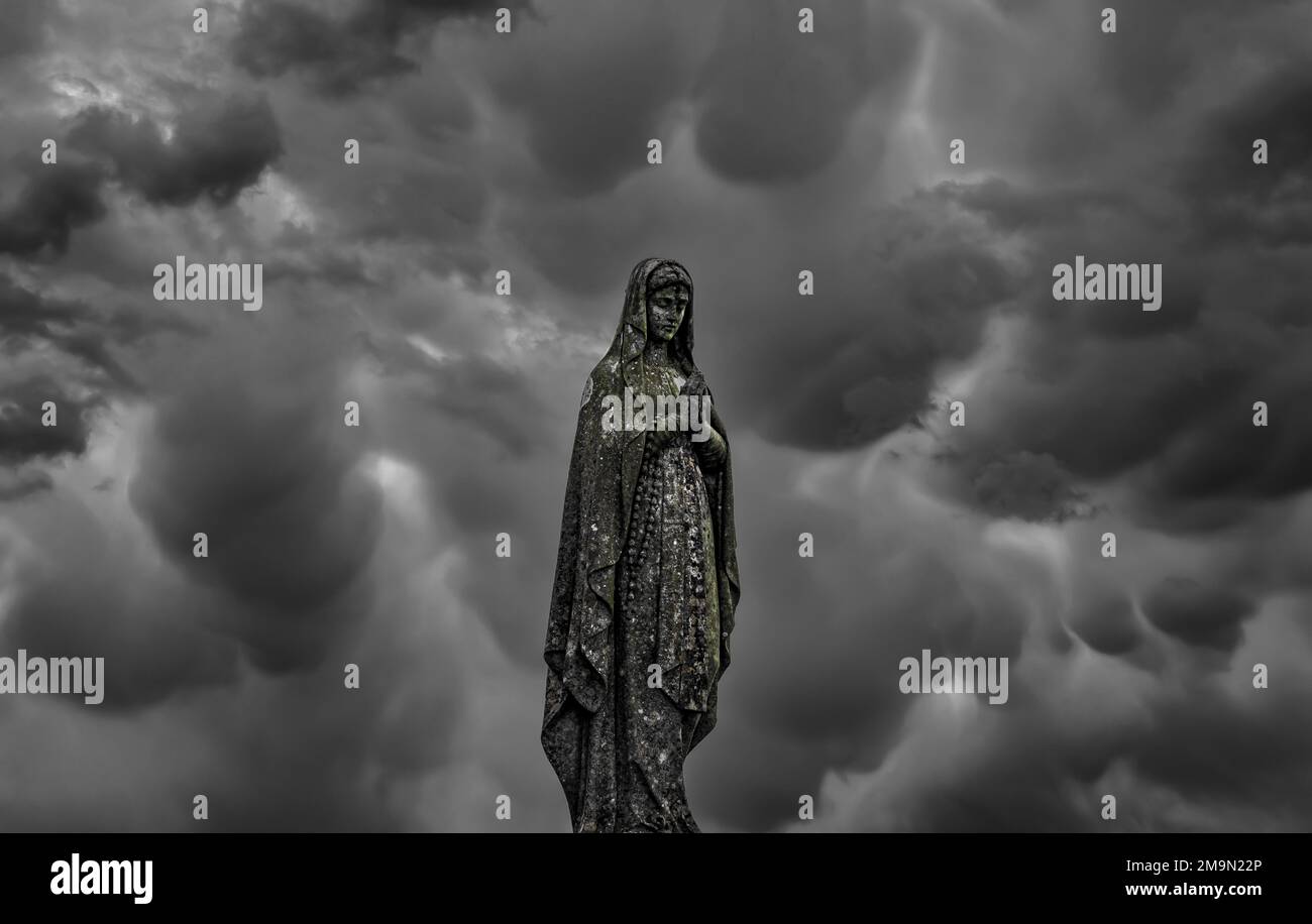 A statue of the Virgin Mary praying at The Rock of Cashel, historic ...