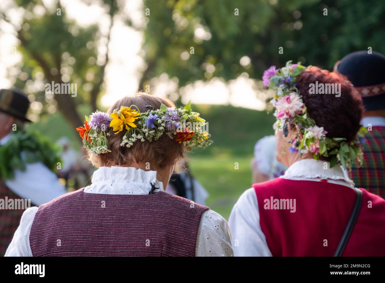 People in folk costumes and herbal wreaths celebrate Midsummer in ...