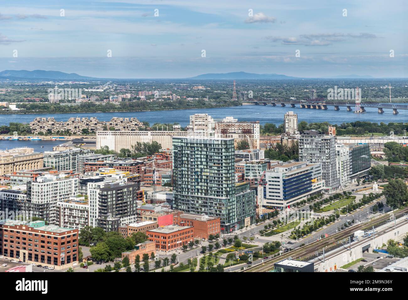 An aerial view of Montreal with Habitat 67 and the Victoria Bridge in ...