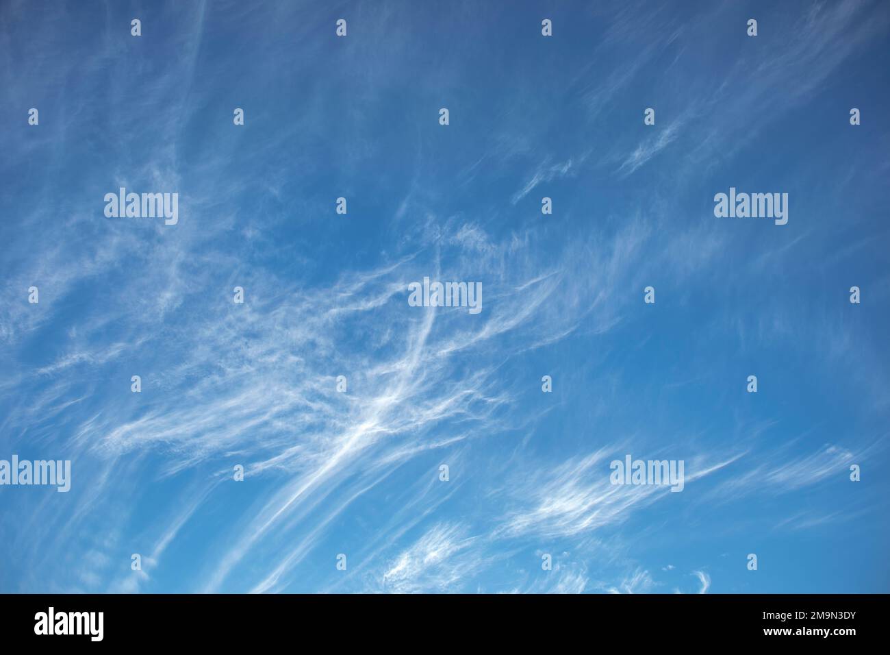 Detail of intense blue sky in broad daylight with fluffy thin white ...