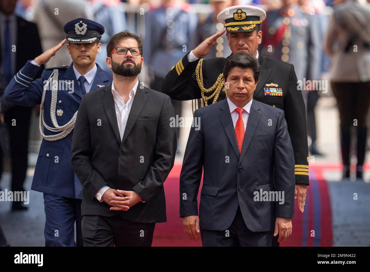 Chilean President Gabriel Boric, left, walks with Peru's President ...