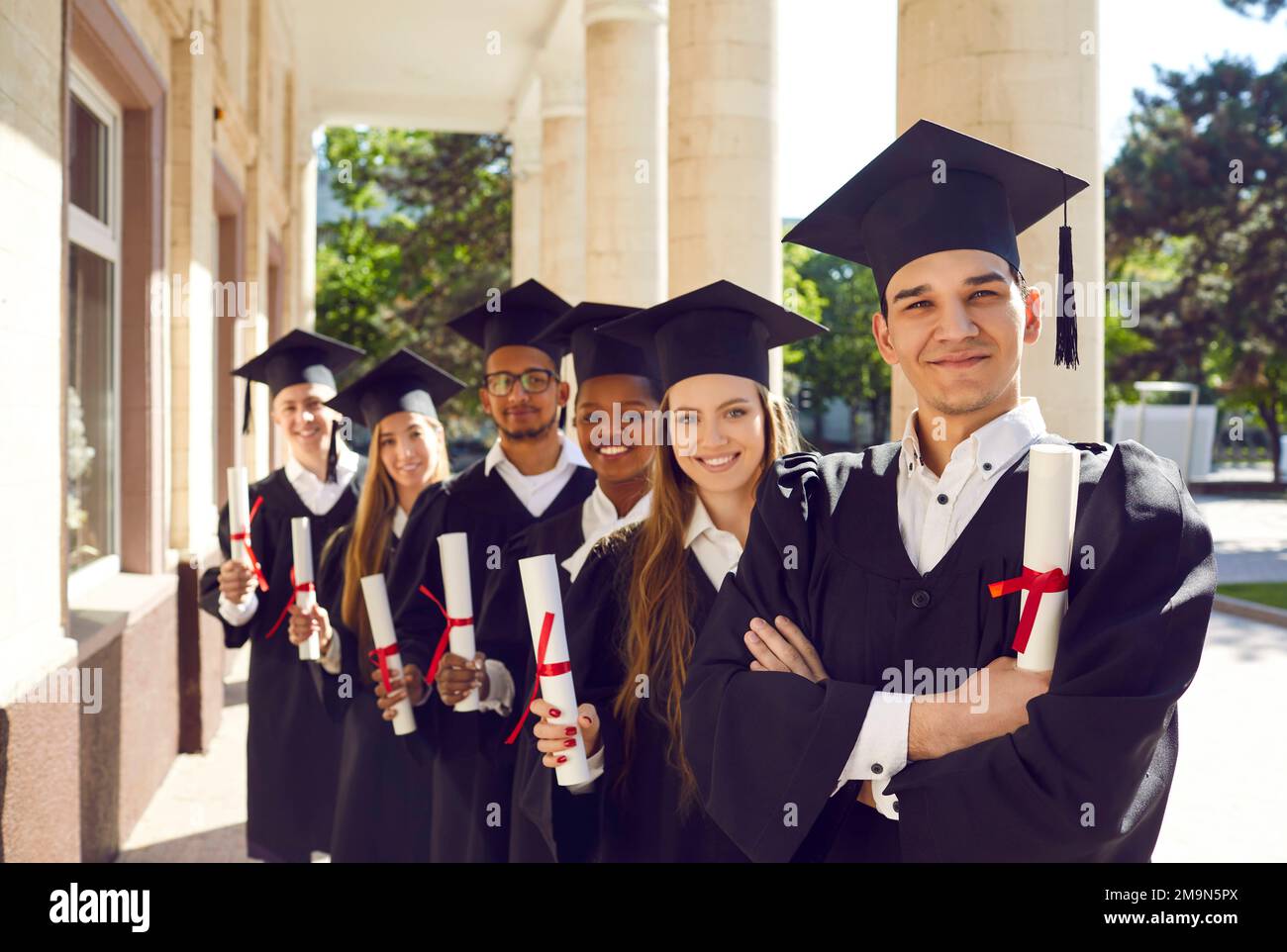 Caps and gowns with diplomas hi-res stock photography and images - Alamy