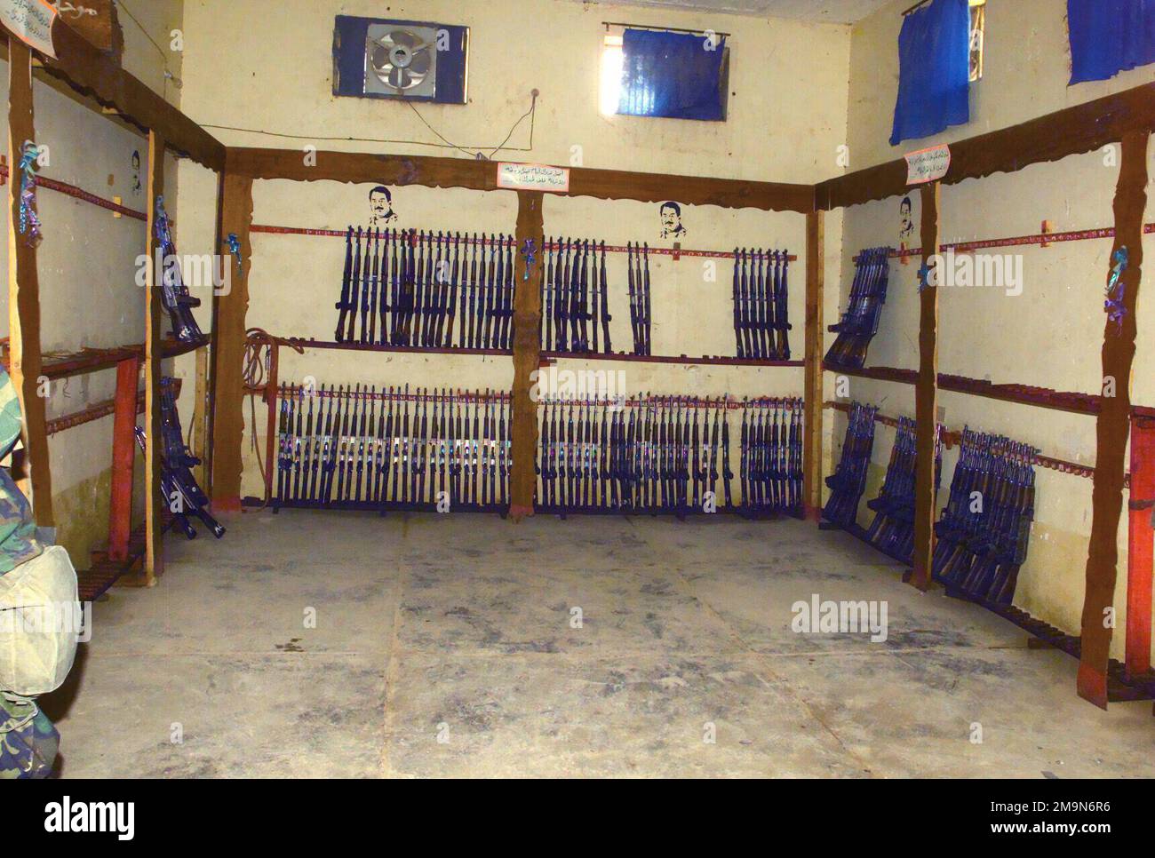 The interior of an Iraqi armory in Al Kut with racks of Tabuk 7.62 mm ...