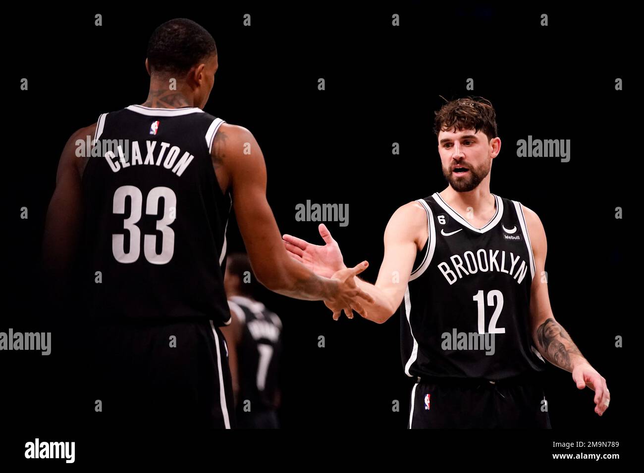 Brooklyn Nets forward Joe Harris (12) slaps hands with forward Nic ...