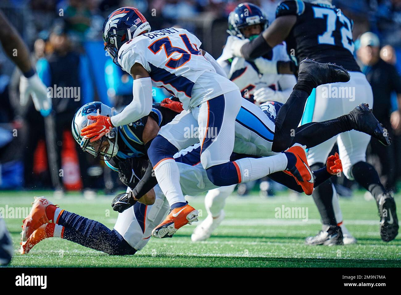 Carolina Panthers running back Chuba Hubbard, center, gets tackled by ...