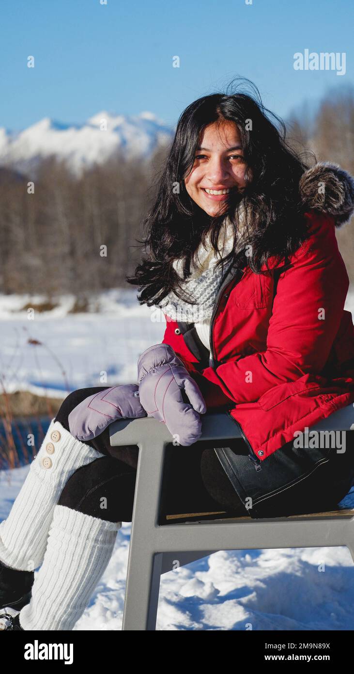 A Young Southeast Asian female smiling to the camera with snowy ...