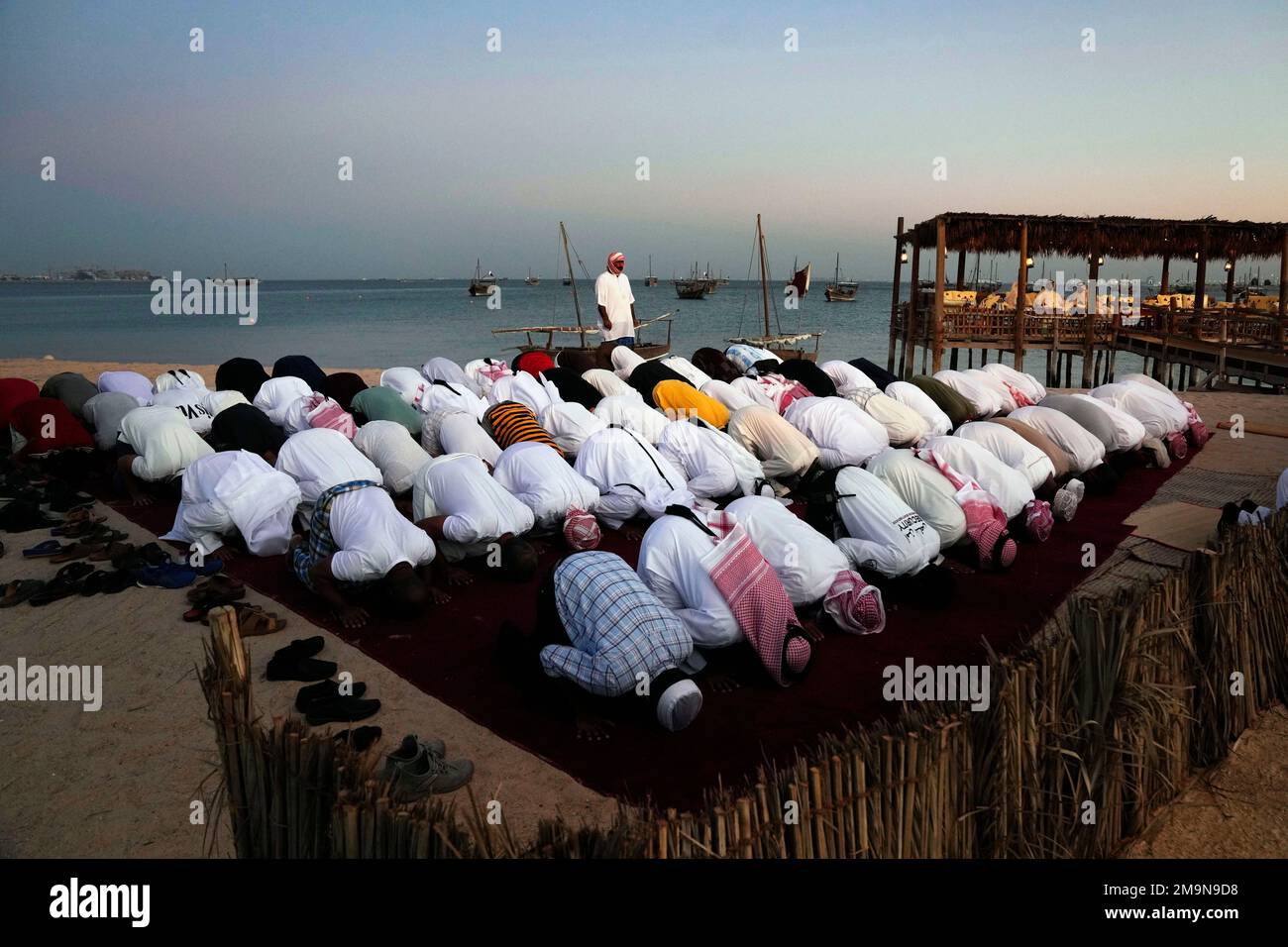 Men pray in Katara beach, Doha, Qatar, Monday, Nov. 28, 2022. (AP Photo ...